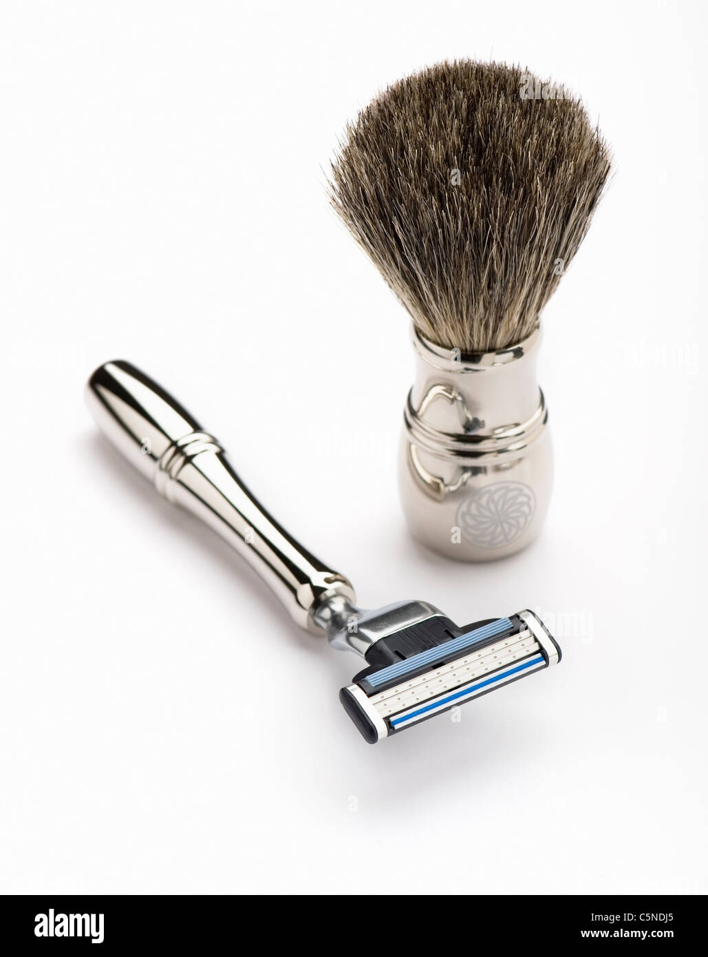 A silver razor and shaving brush Stock Photo - Alamy