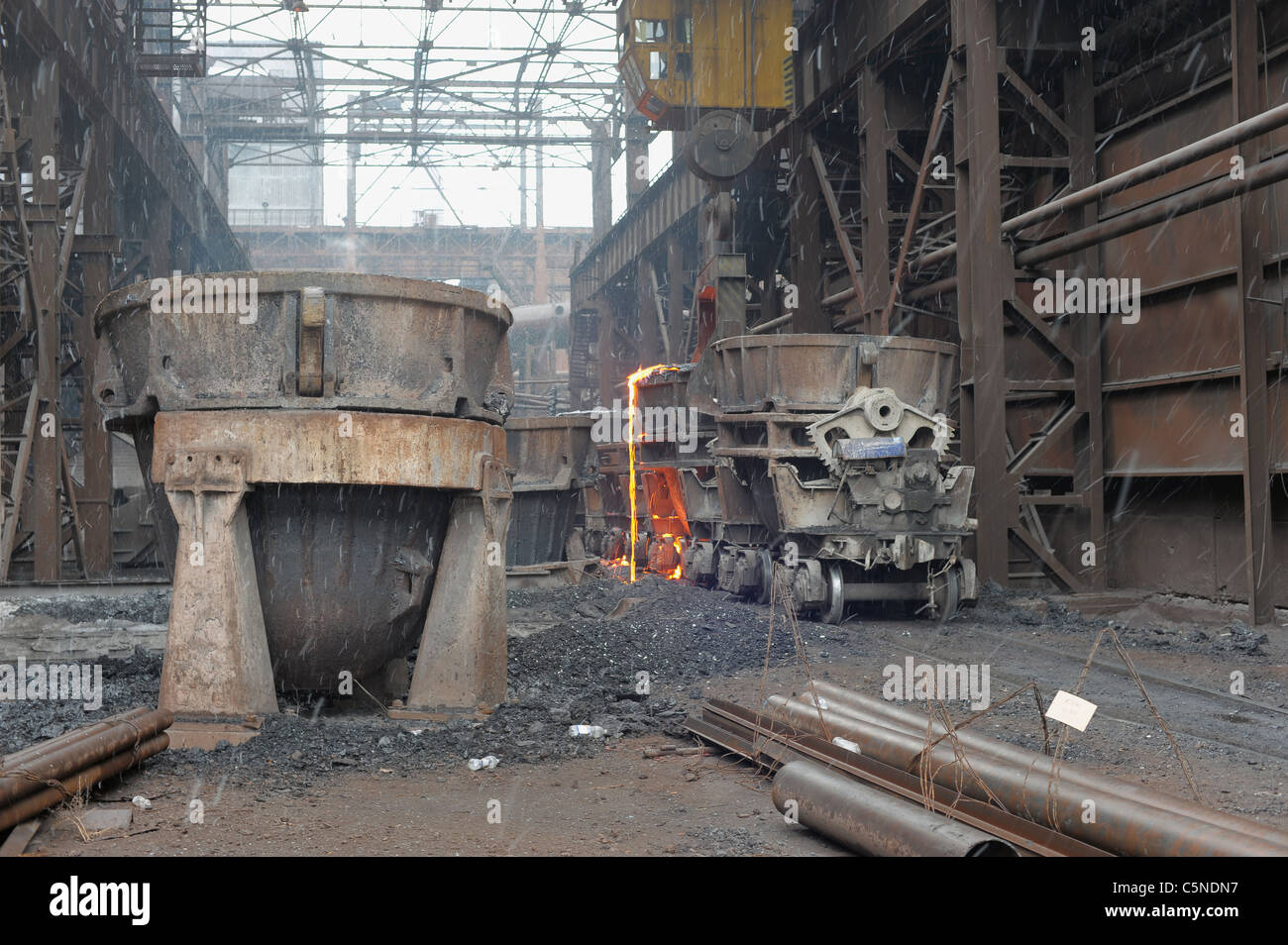 The fused metal pours out from a ladle on a railway platform Stock ...