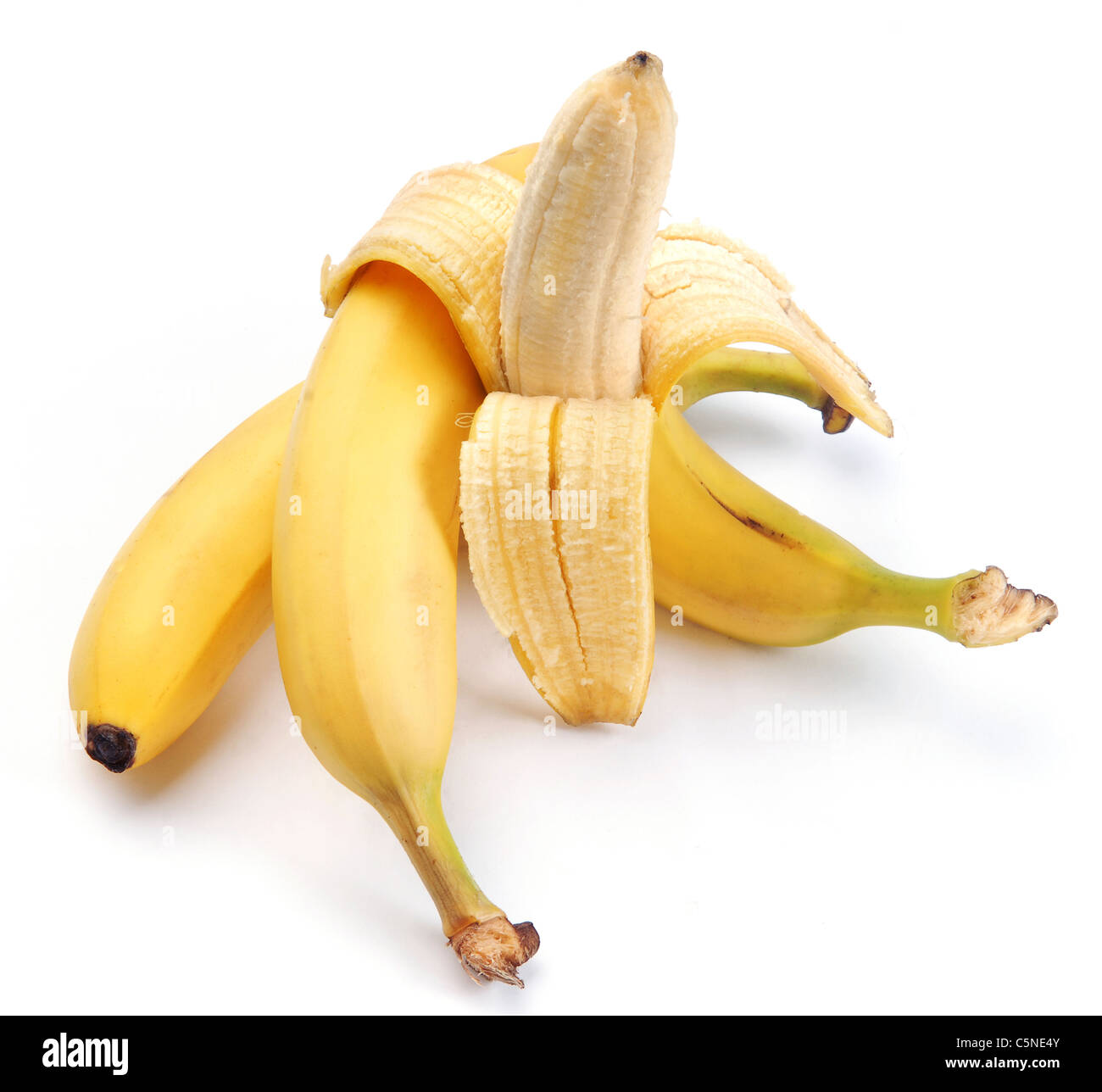 Ripe bananas and one half cleared on a white background Stock Photo - Alamy