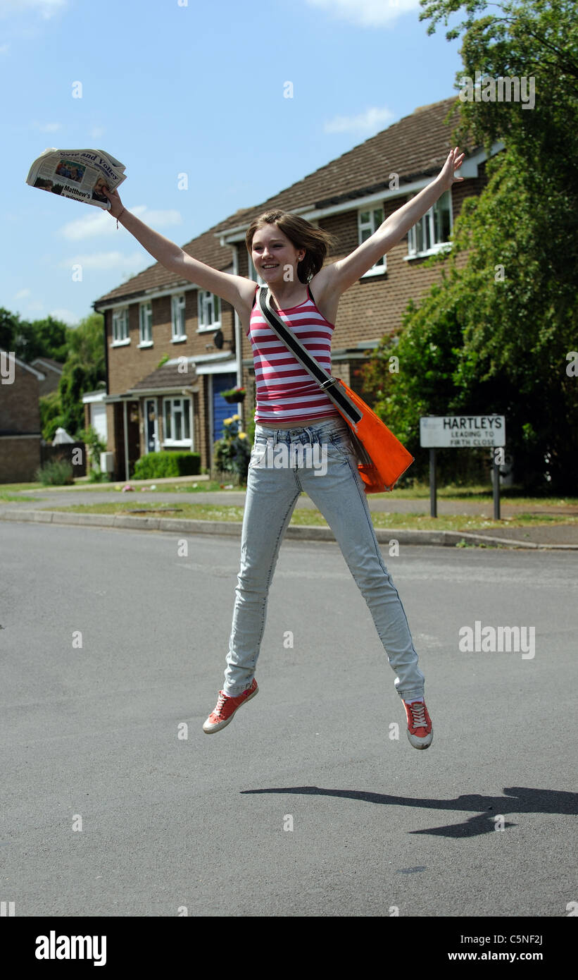 Young girl happy with her spare time job delivering newspapers Stock ...
