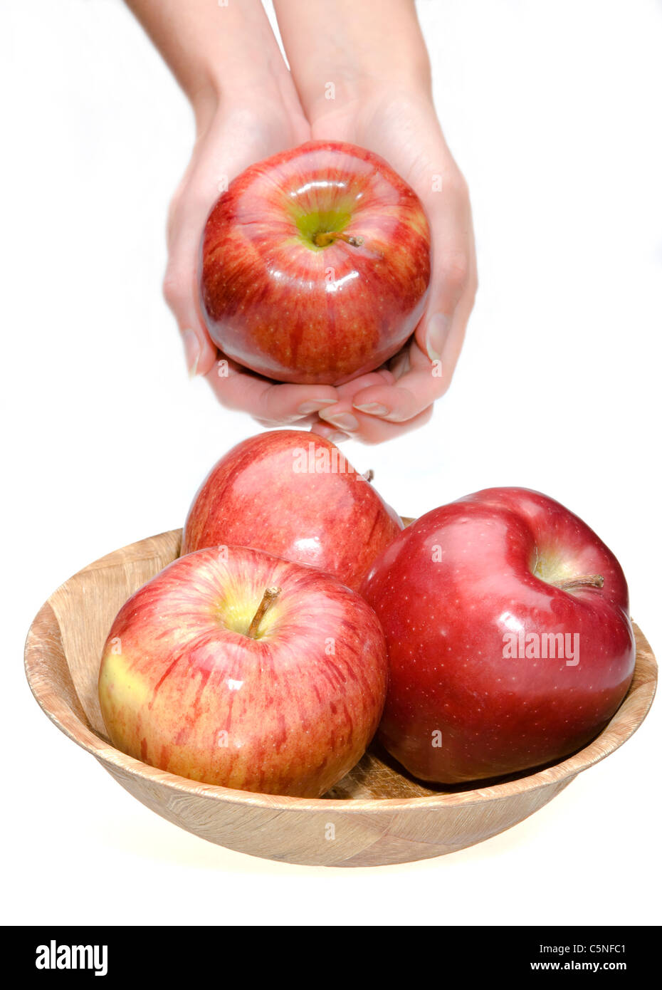 Hands stretch apple and bowl with apples Stock Photo - Alamy