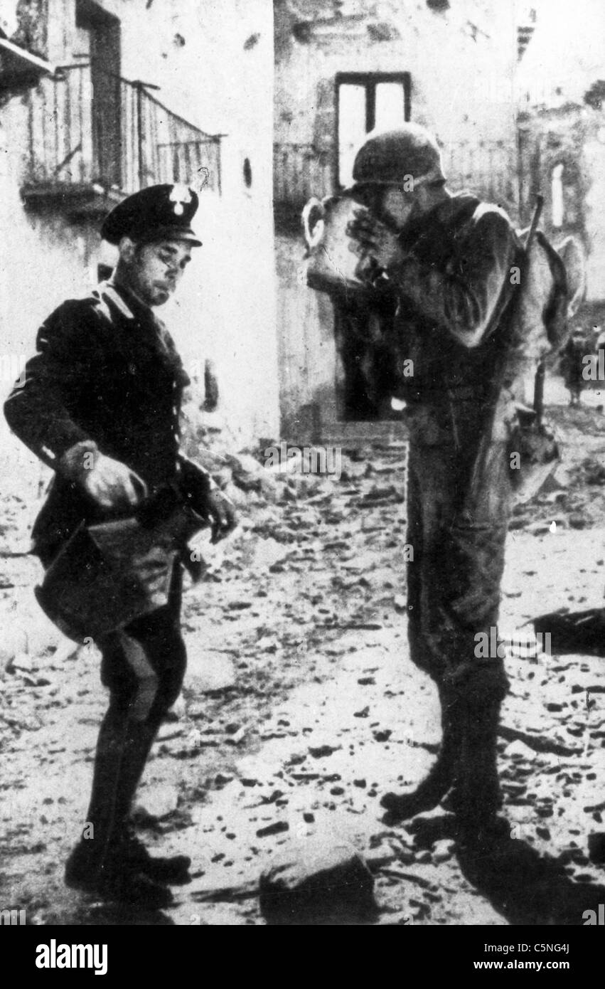 a carabiniere gives water to a U.S. military, World War II, 1944 Stock ...