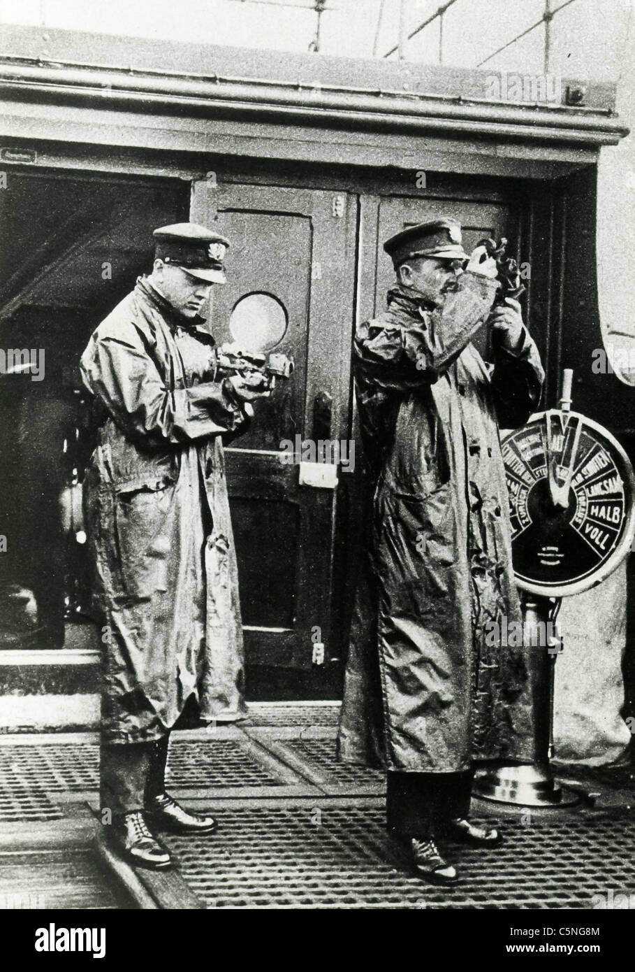 command bridge of a British ship, two officers are studying the route ...