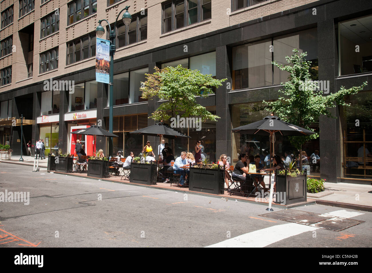 Lunching office workers take advantage of a pop-up seating "cafe" in ...