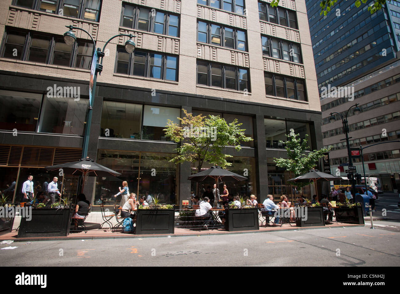 Lunching office workers take advantage of a pop-up seating "cafe" in ...