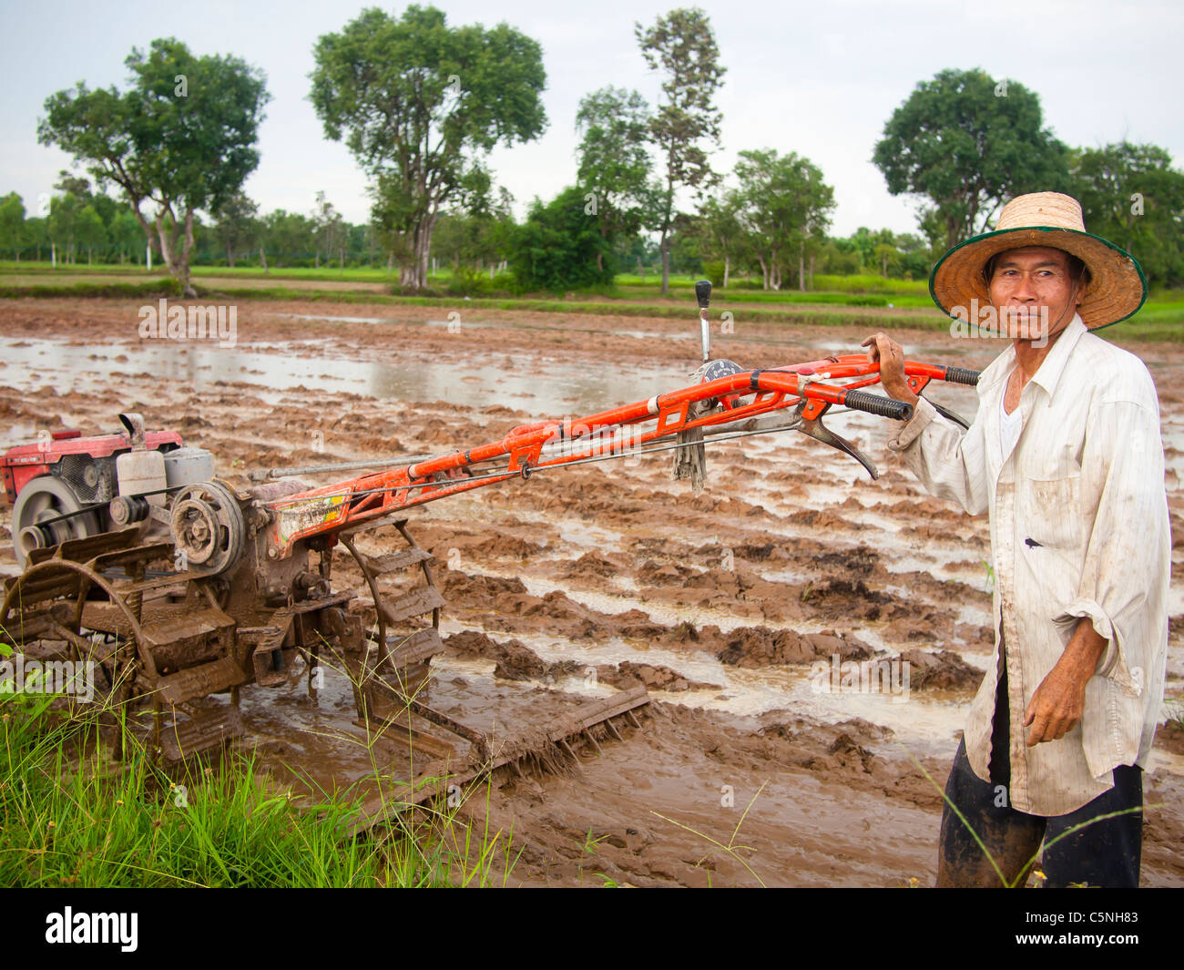 Farmer is using plow tracker on his rice farm Stock Photo - Alamy