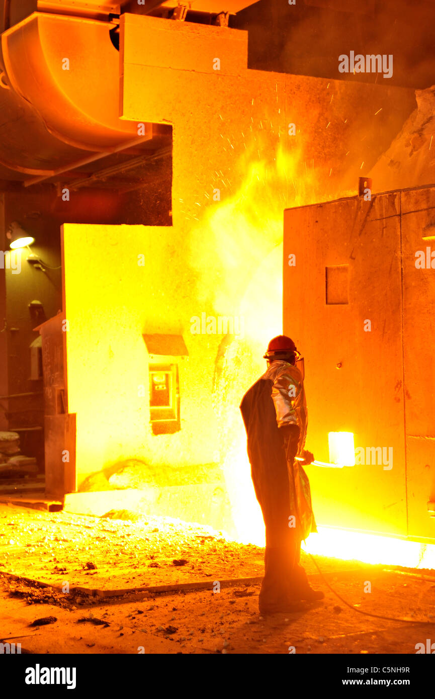 Molten hot steel pouring and worker Stock Photo - Alamy