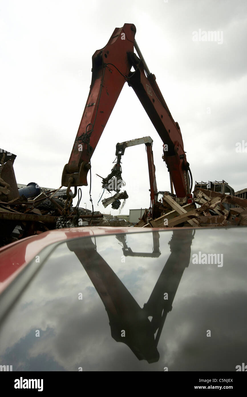 Crane lifting scrap metal for recycling in a scrapyard, uk Stock Photo ...