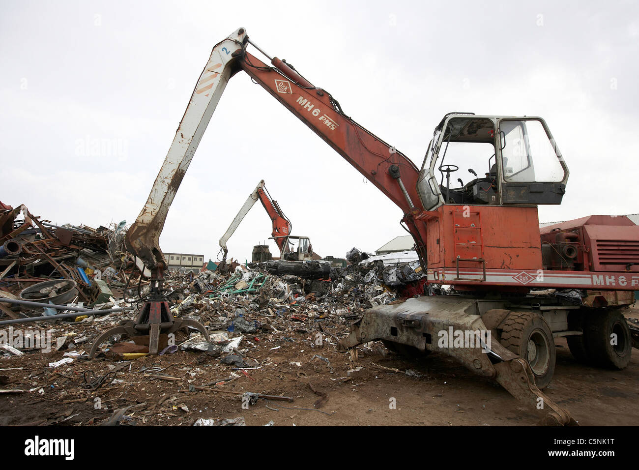 Crane lifting scrap metal for recycling in a scrapyard, uk Stock Photo ...