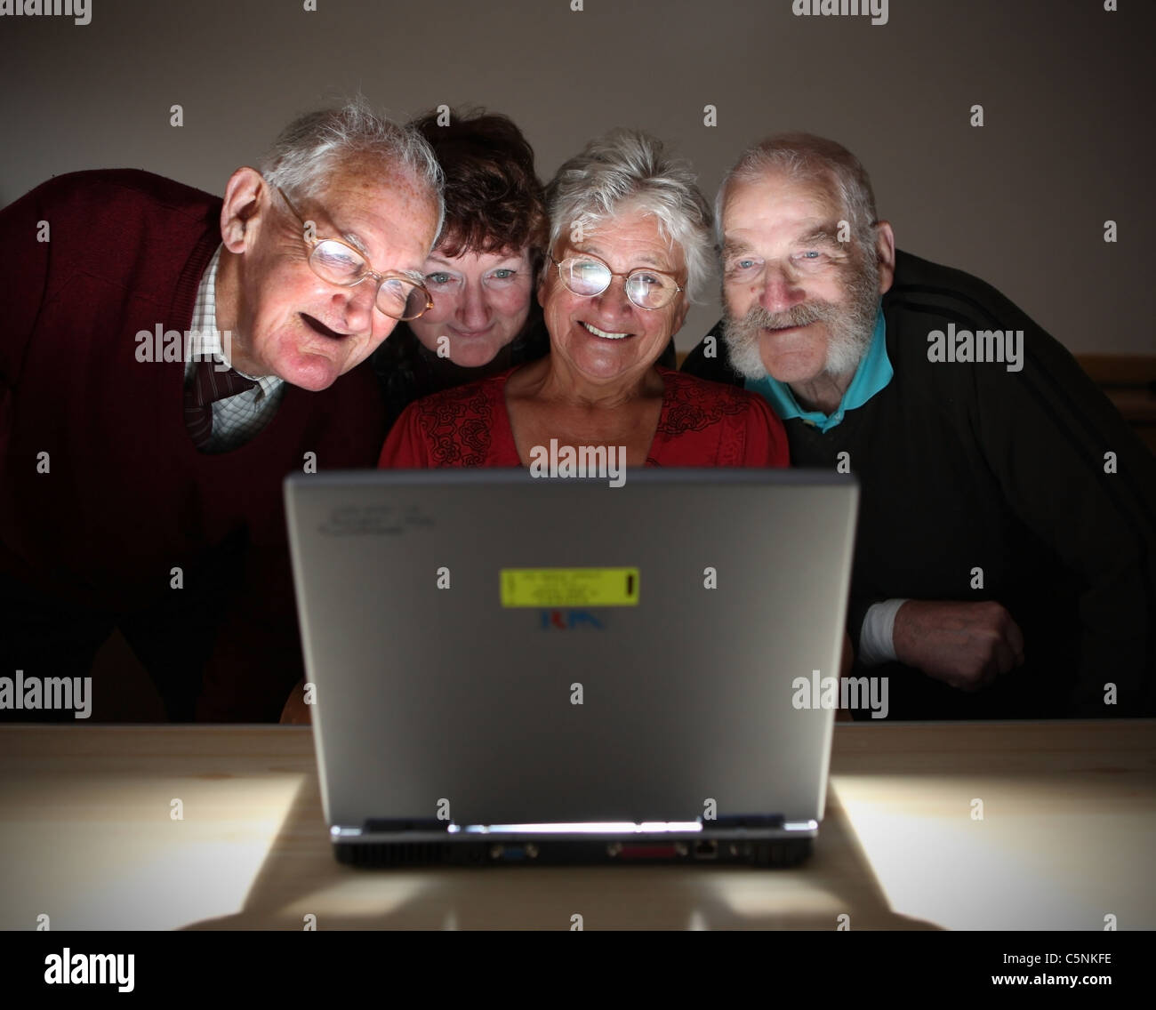 Older people looking at the screen and enjoying using a modern laptop ...