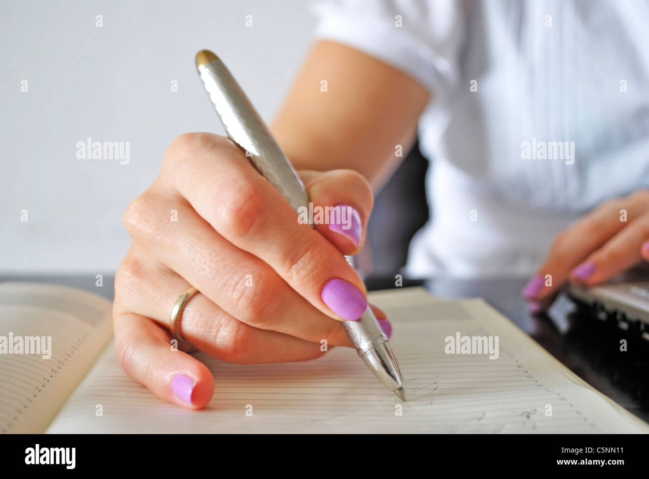 Business women writing Stock Photo - Alamy