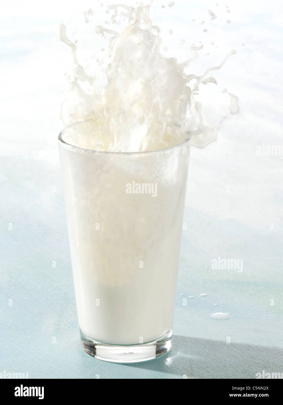 Milk splashing out of a glass Stock Photo - Alamy
