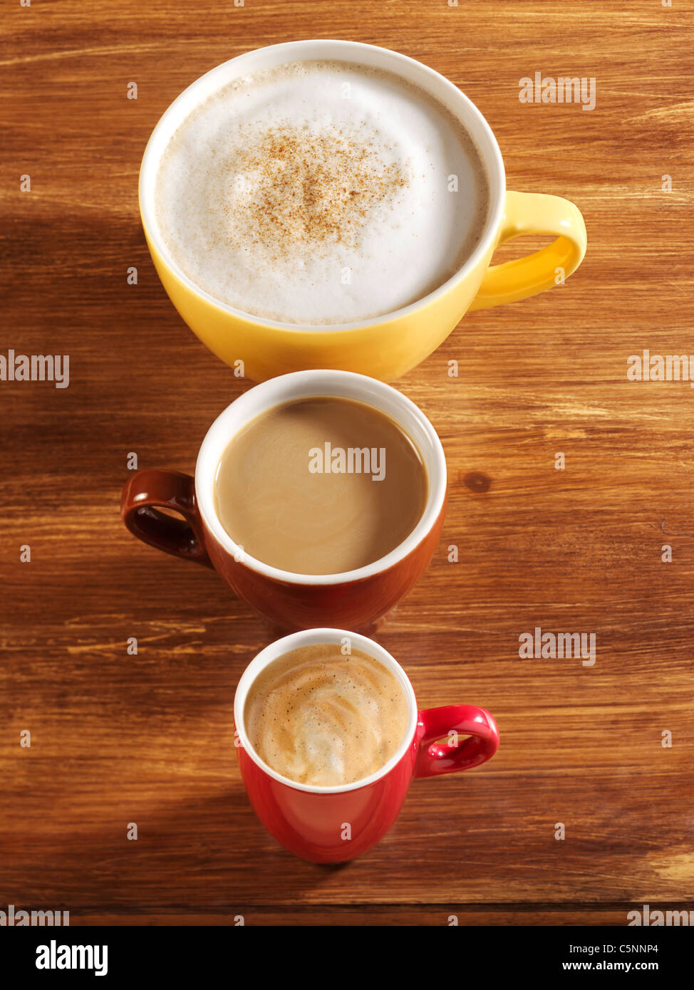 Three cups of Cappuccino with grounded cinnamon, coffee with milk ...