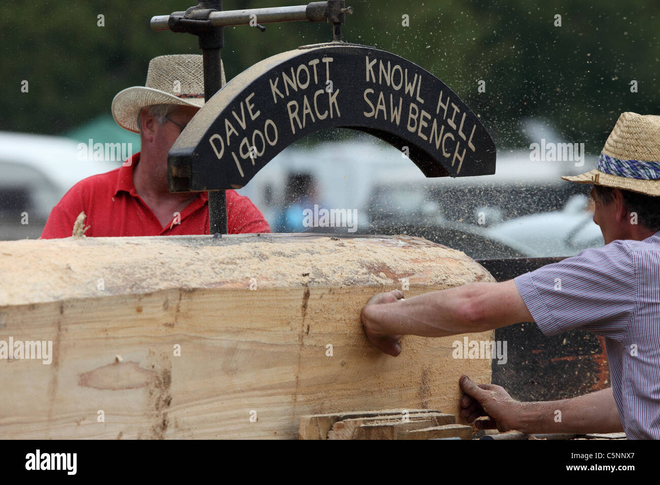 A men using A saw bench powered by A steam traction engine Stock Photo ...