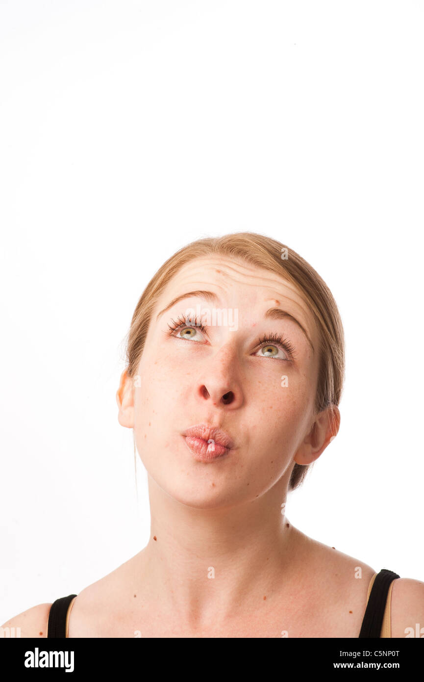 a young caucasian woman looking upwards confused thinking pondering ...