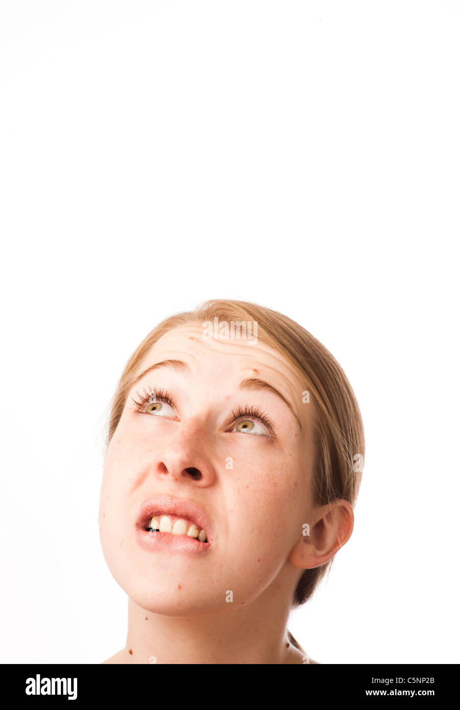 a young caucasian woman looking upwards confused Stock Photo - Alamy