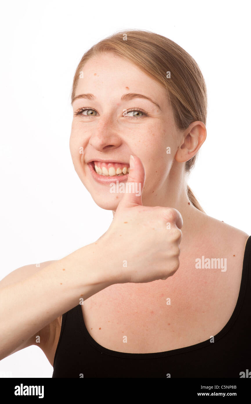 a young caucasian woman with her thumbs up looking positive, uk Stock ...