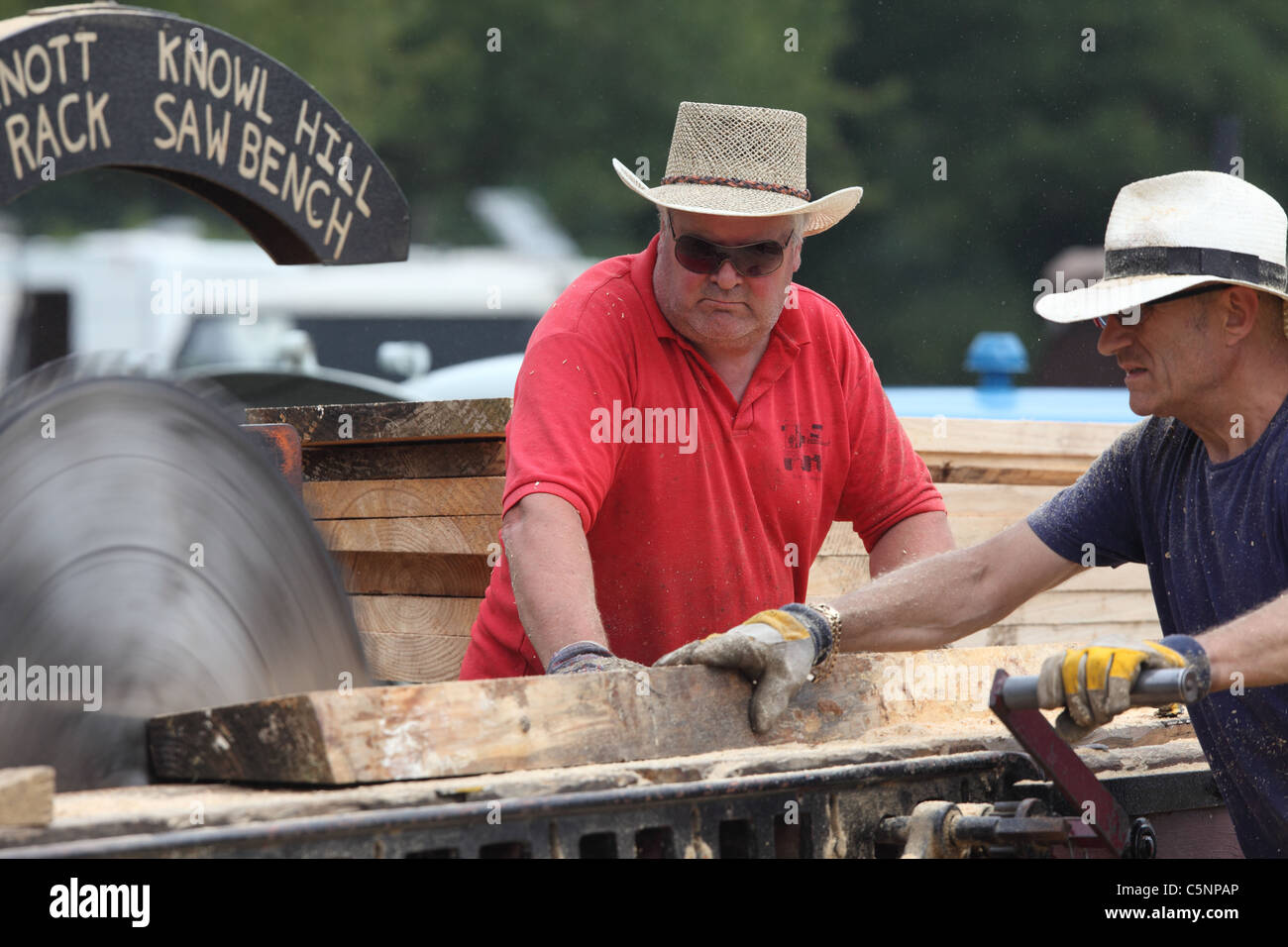Men working A saw bench powered by A steam traction engine Stock Photo ...