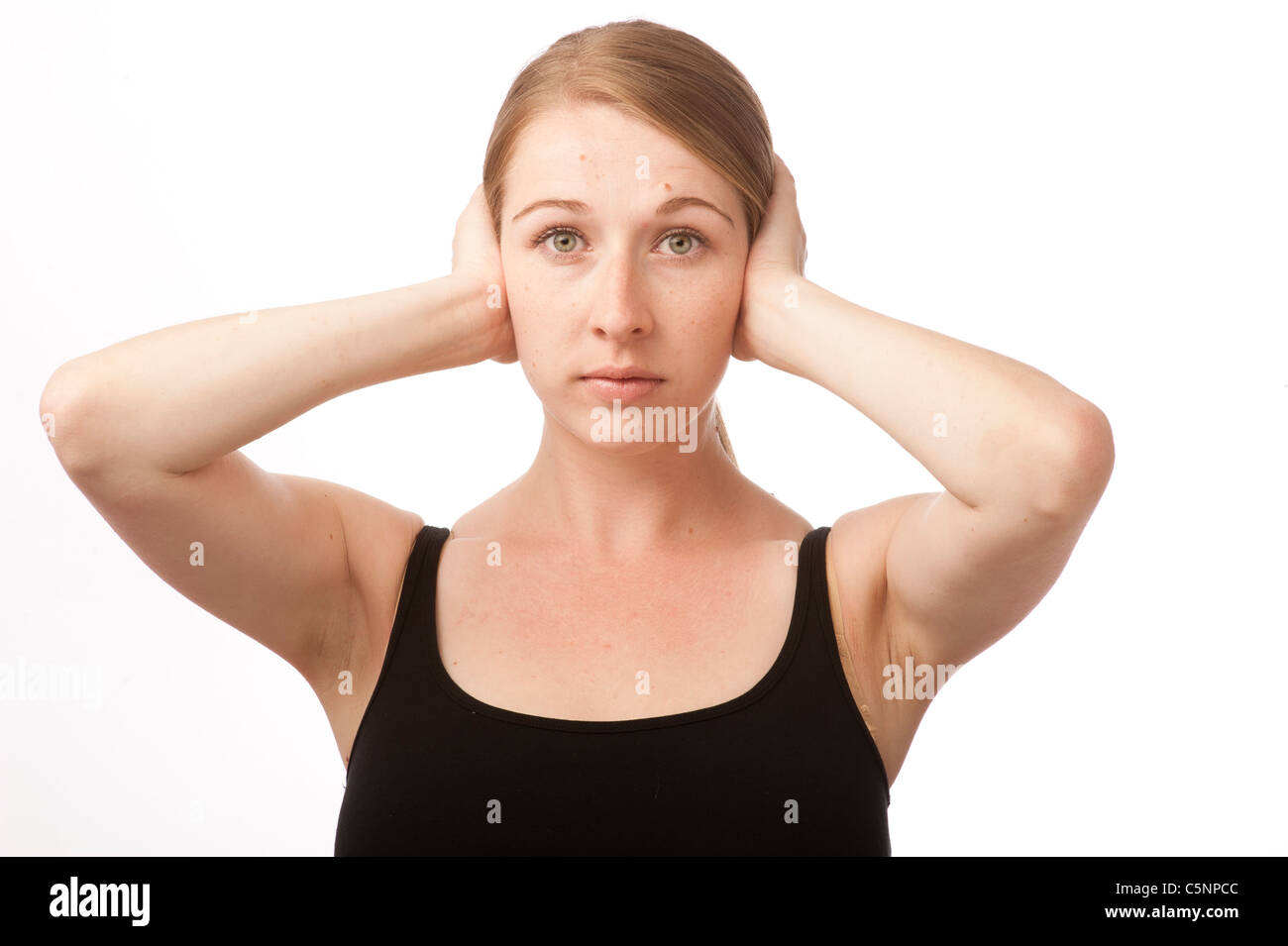 Young woman with hands over ears hi-res stock photography and images ...