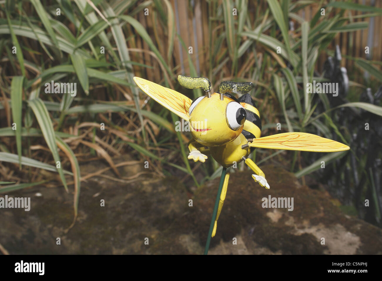image of plastic bee ornament in garden Stock Photo - Alamy