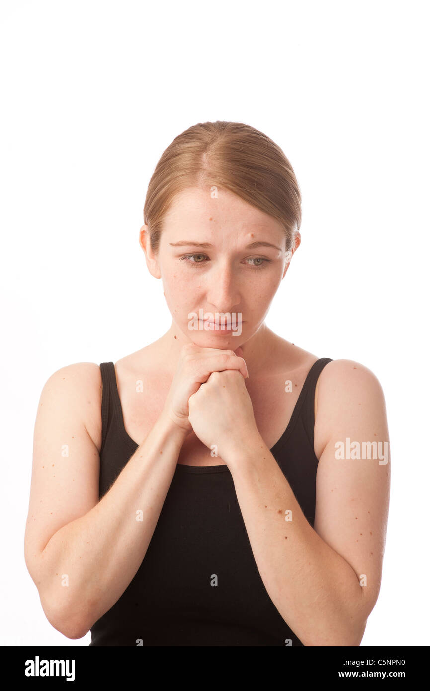 a young caucasian woman looking worried anxious concerned with her ...