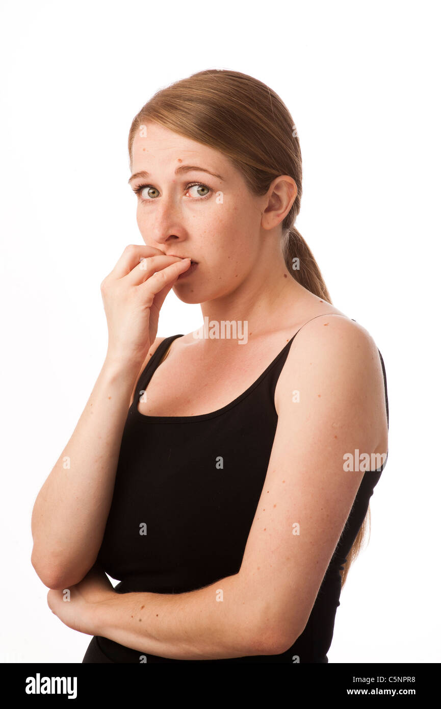 a young caucasian woman looking worried anxious concerned biting her ...