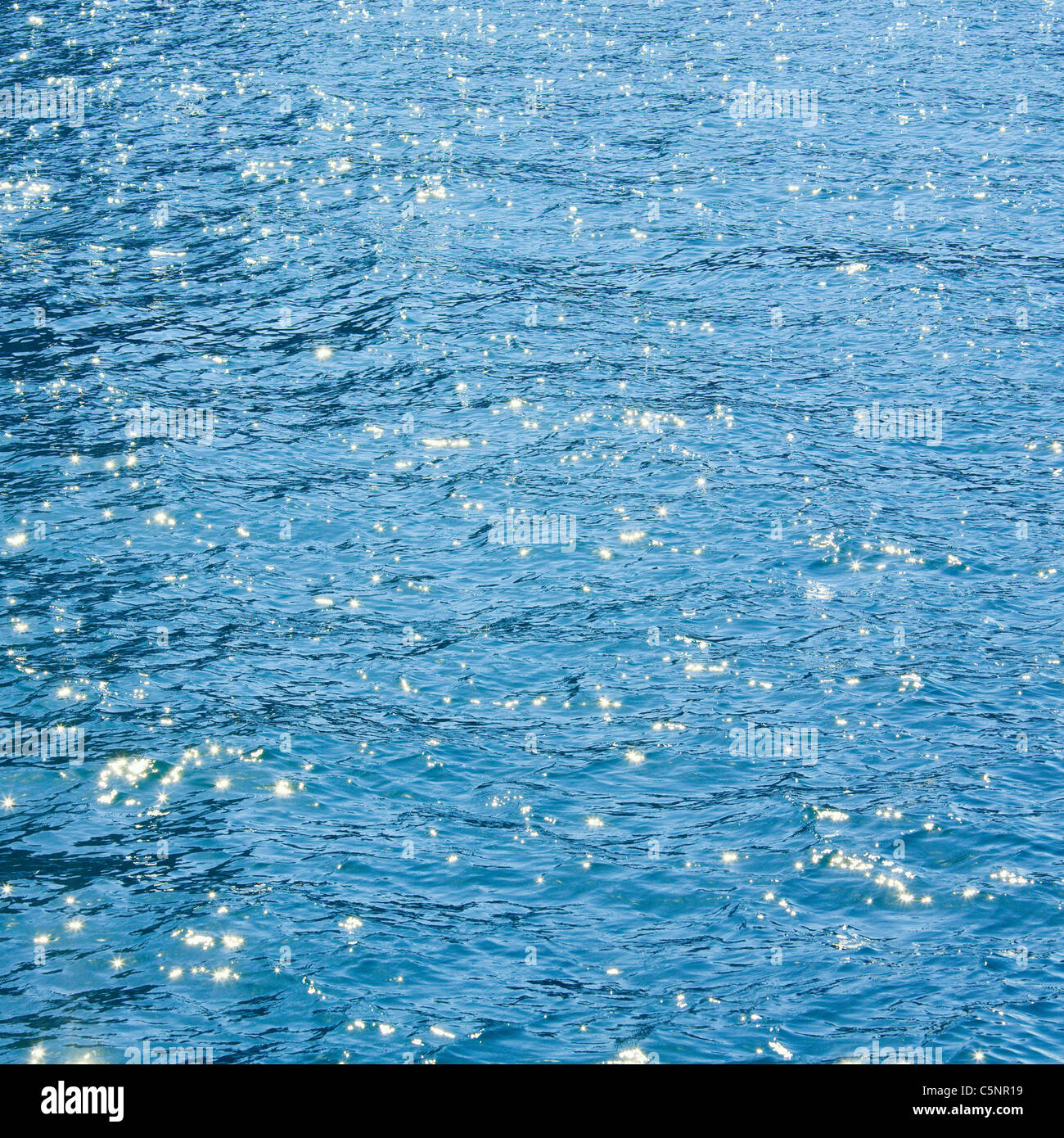 Azure sea water surface with ripple and sun reflections Stock Photo - Alamy