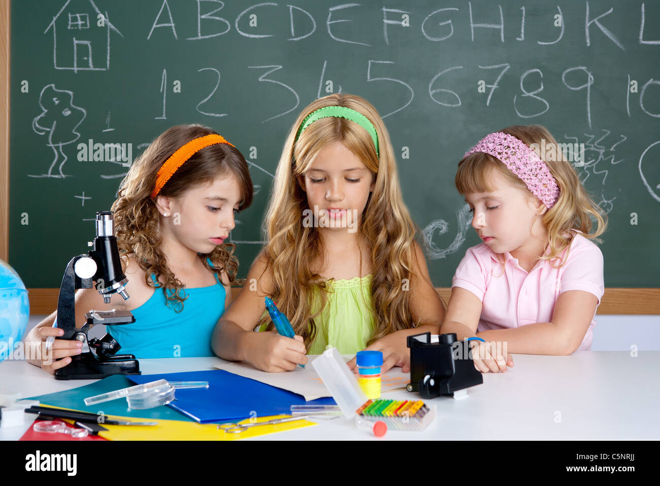 kids group of student girls at school classroom as children teamwork ...