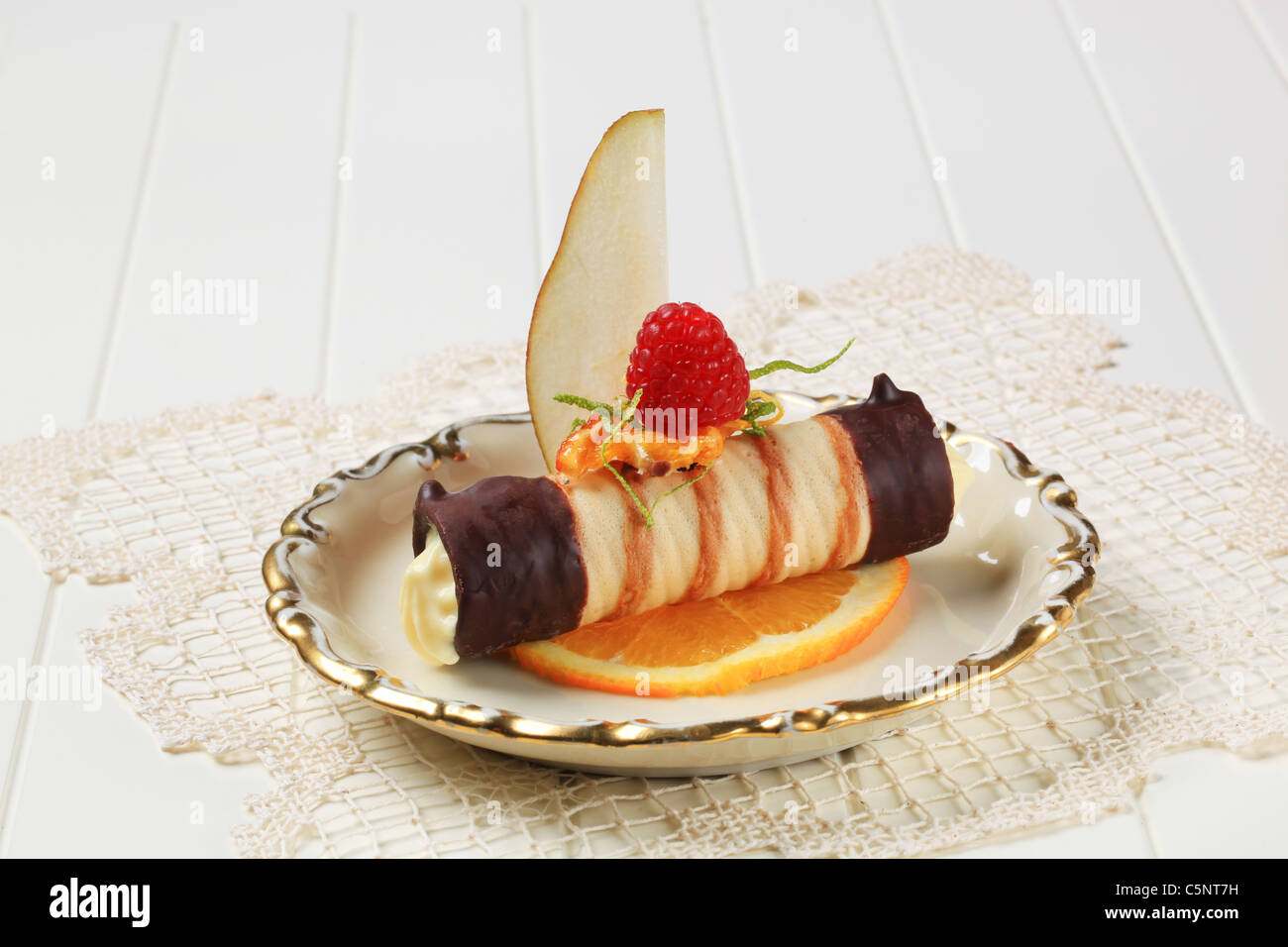 Chocolate dipped wafer tube filled with cream Stock Photo - Alamy