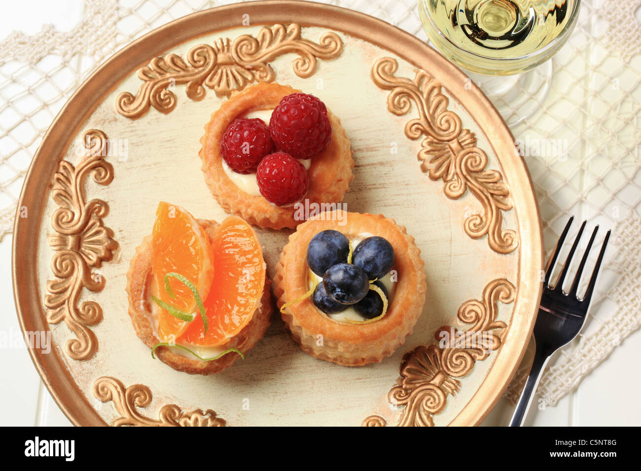 Puff pastry shells filled with custard and fresh fruit Stock Photo - Alamy