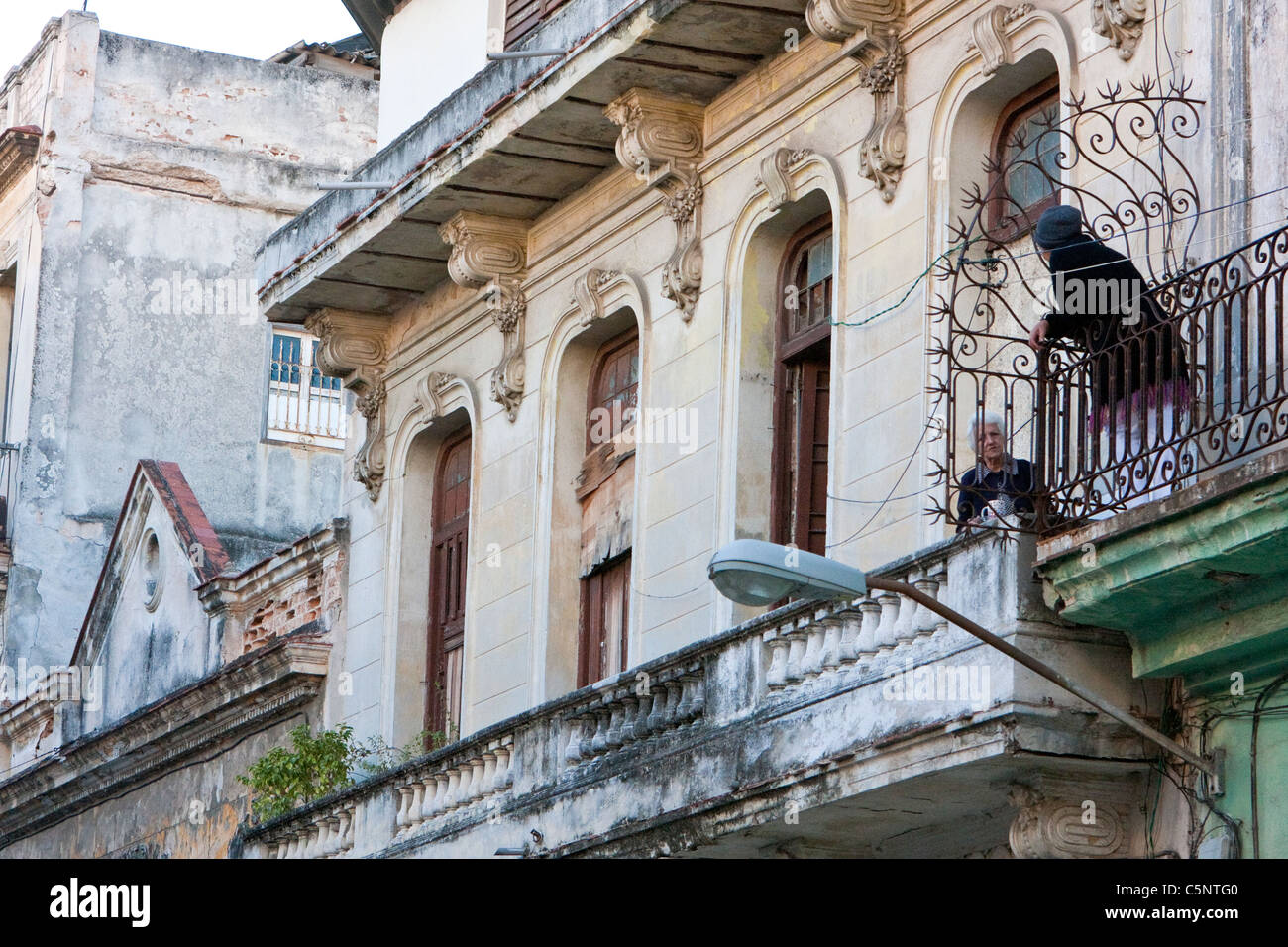 Cuba, Havana. Balcony Scene. Two Women Talking Stock Photo - Alamy