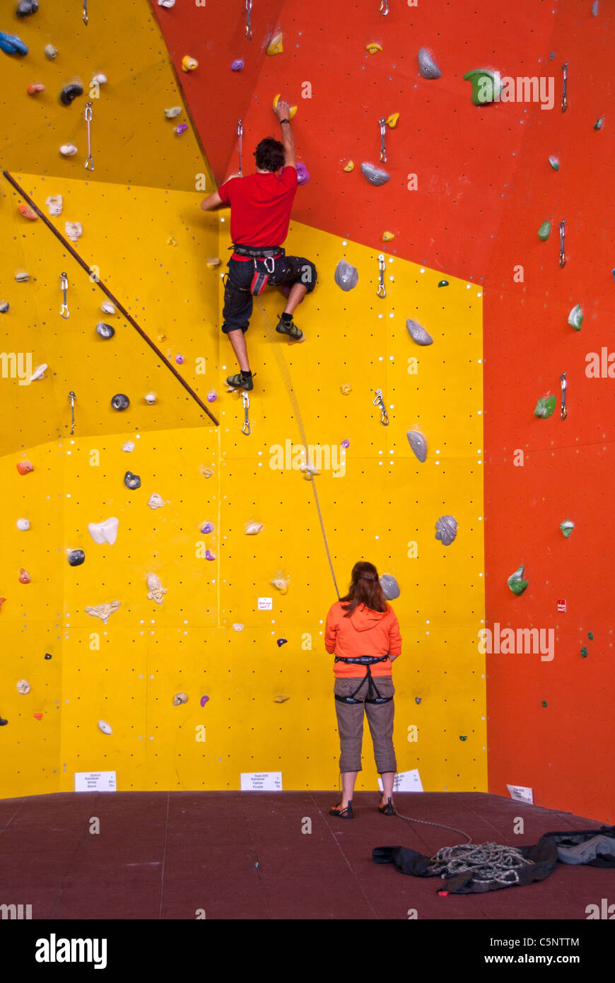 INDOOR PERSON IN ROCK CLIMBING WHILE OTHER OBSERVING Stock Photo - Alamy