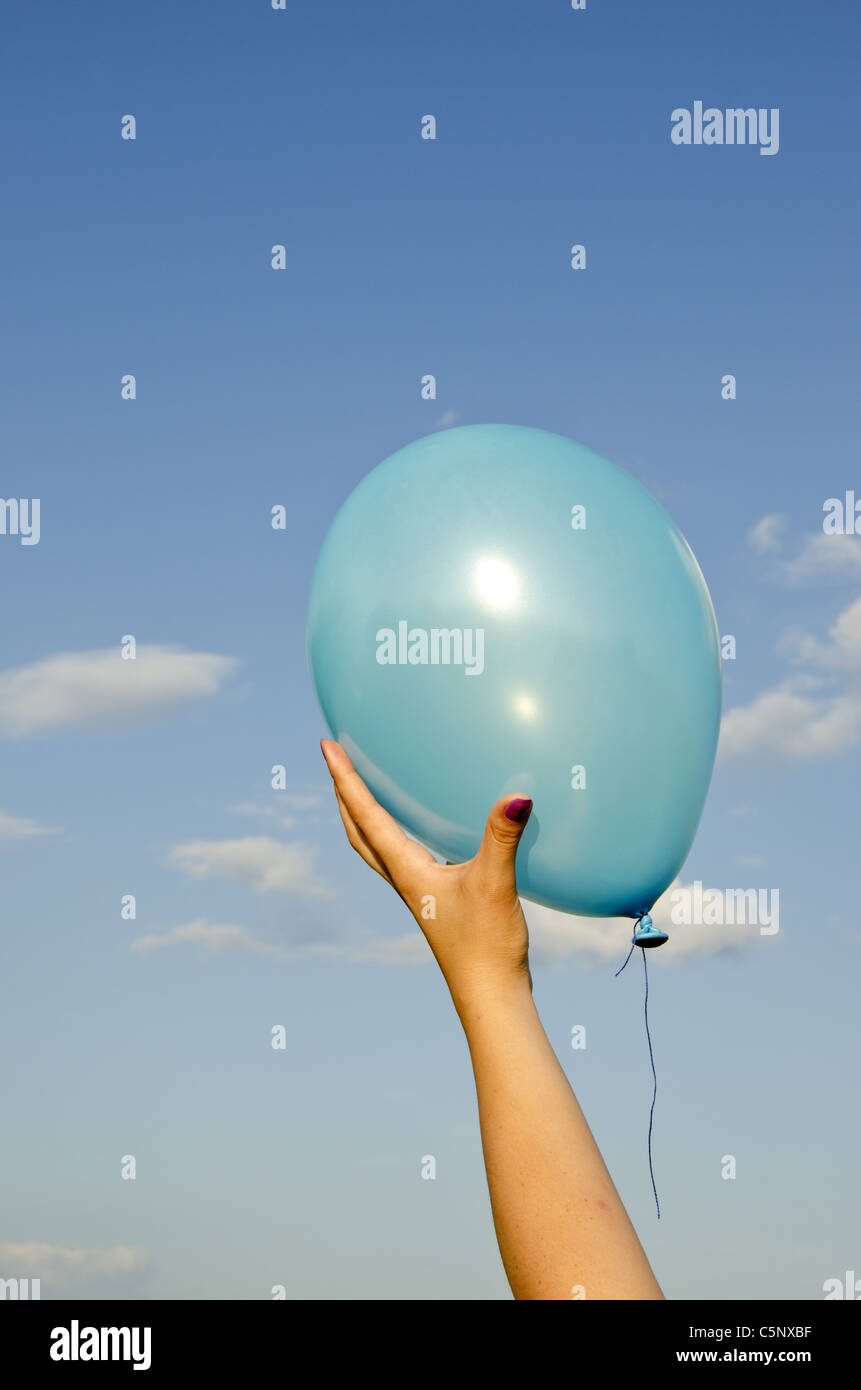 girl hand holding azure balloon and sky Stock Photo - Alamy