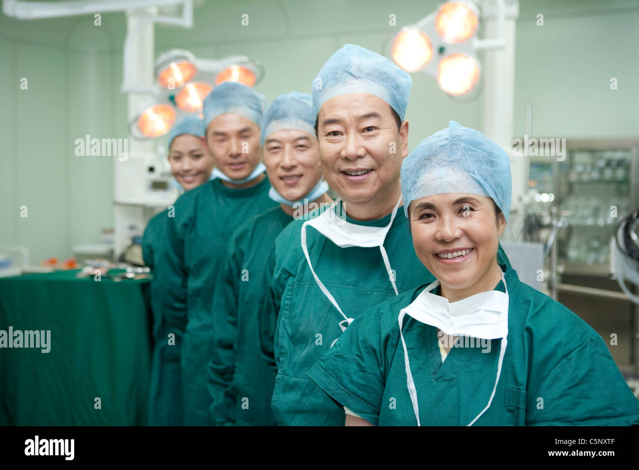 Portrait of a team of surgeons standing in a line Stock Photo - Alamy