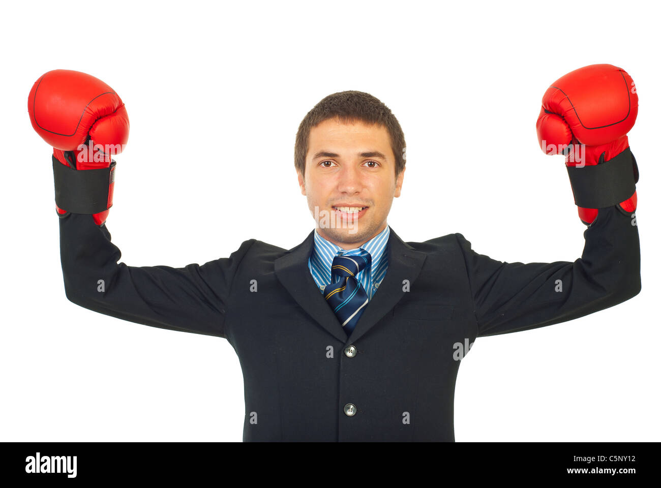 Cheerful winner business man raising hands in boxing gloves against ...