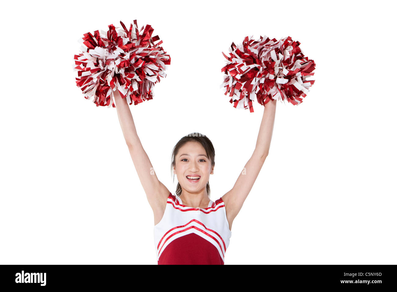 Cheerleader in action with her pom-poms Stock Photo - Alamy