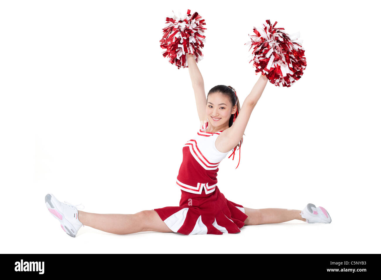 Cheerleader in action with her pom-poms Stock Photo - Alamy