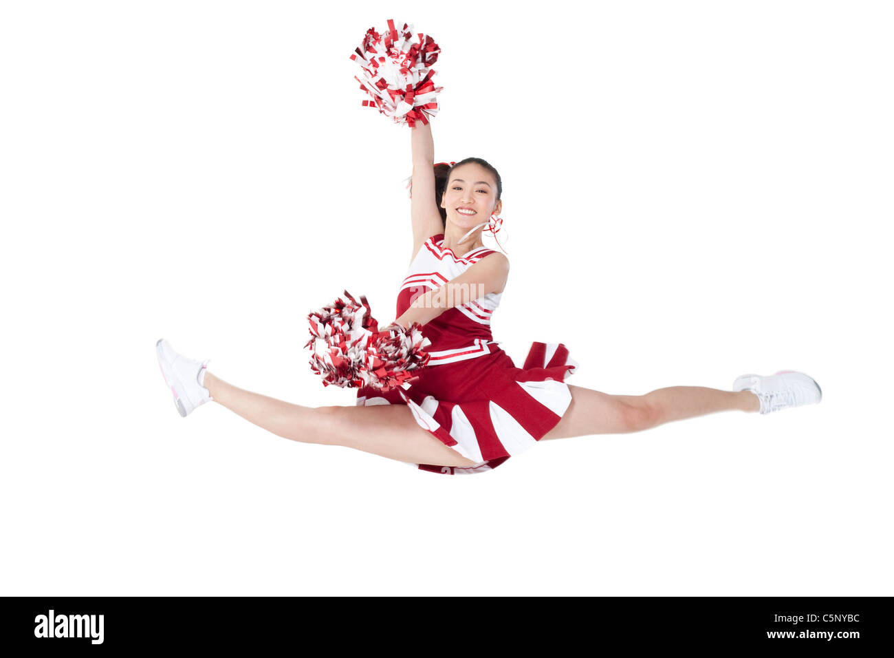 Cheerleader in action with her pom-poms Stock Photo - Alamy