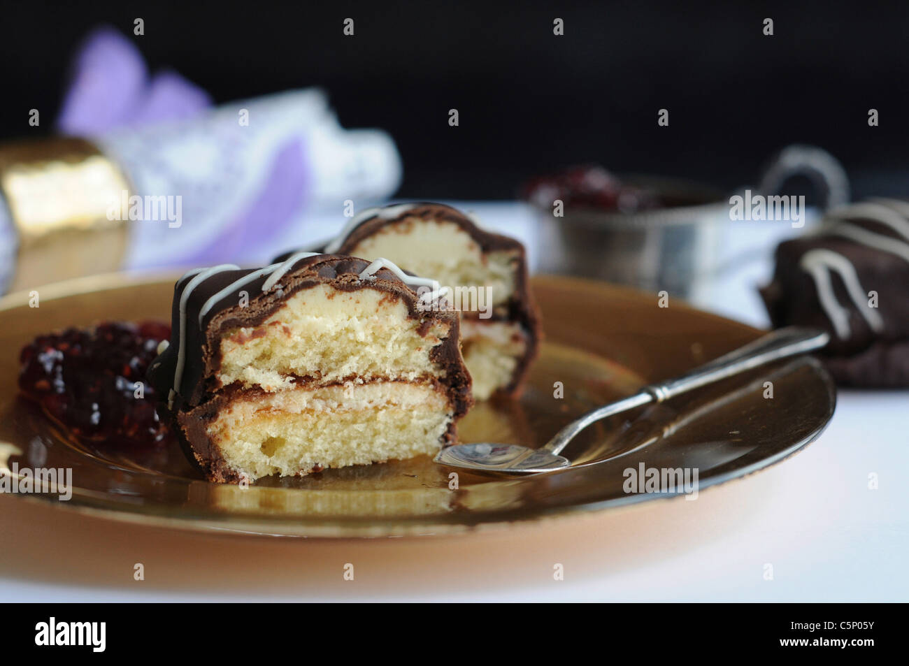 Dark belgian chocolate fondant fancies with strawberry jam Stock Photo ...