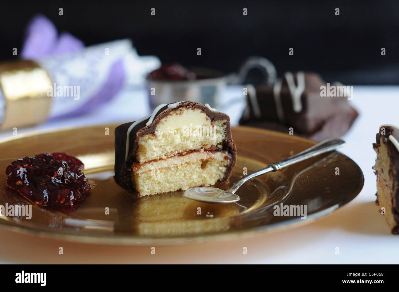 Dark belgian chocolate fondant fancies with strawberry jam Stock Photo ...