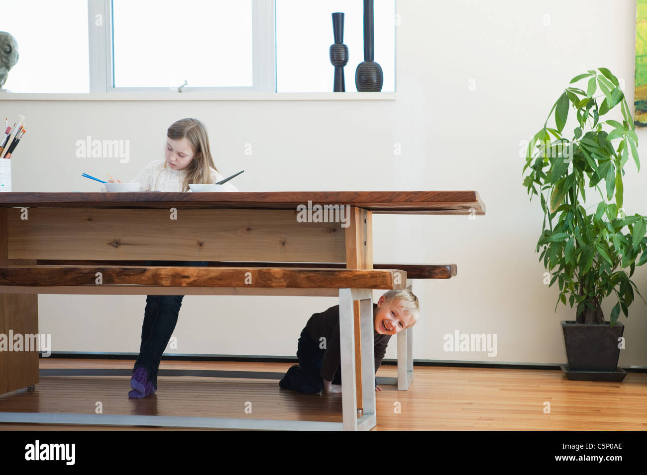 Boy hiding under table hi-res stock photography and images - Alamy