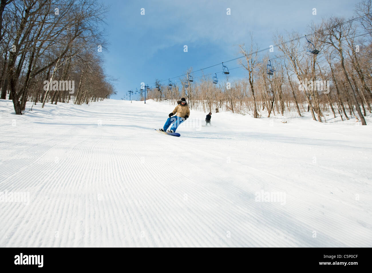 Two people snowboarding Stock Photo - Alamy