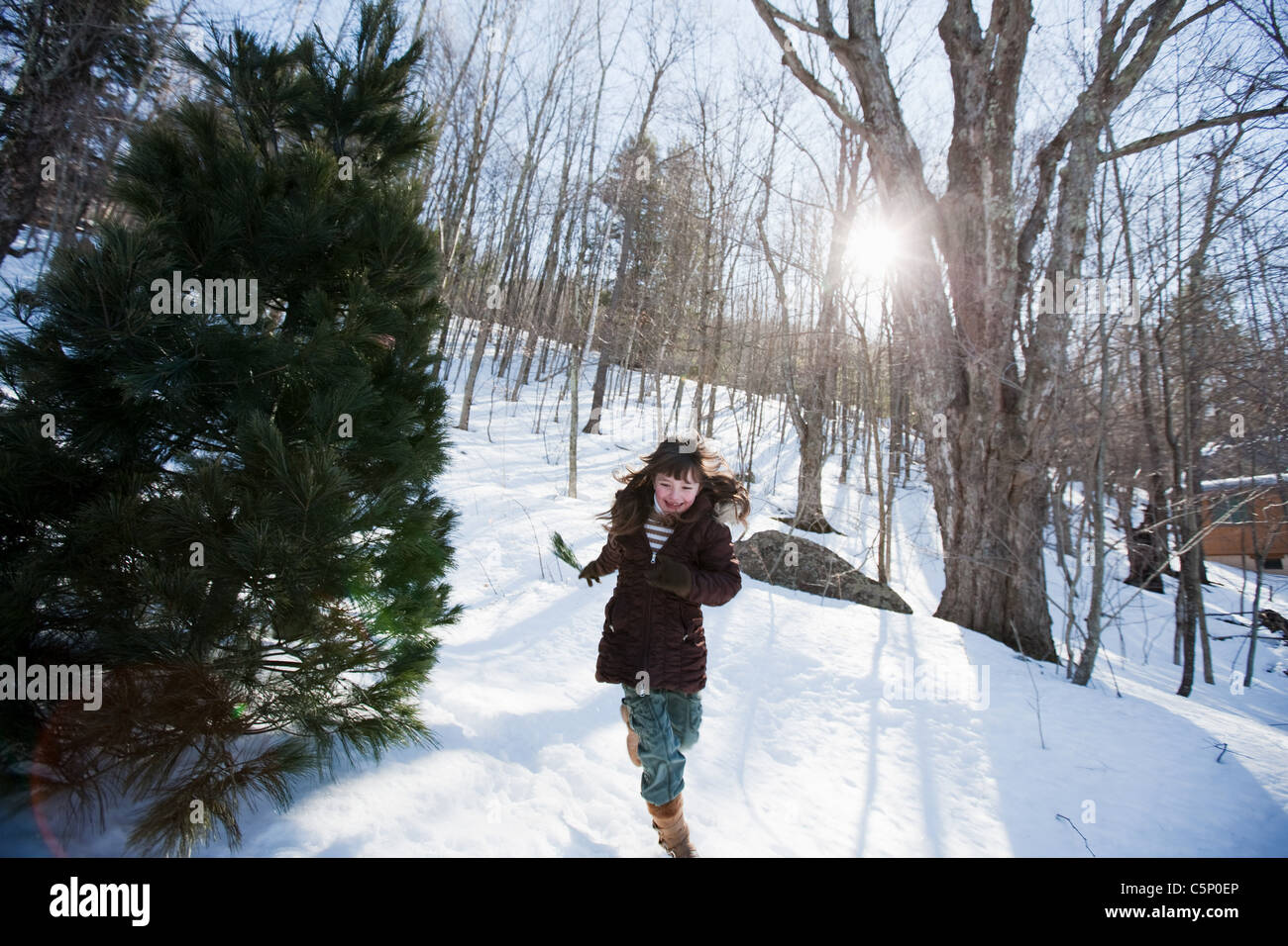 Girl running in snow Stock Photo - Alamy