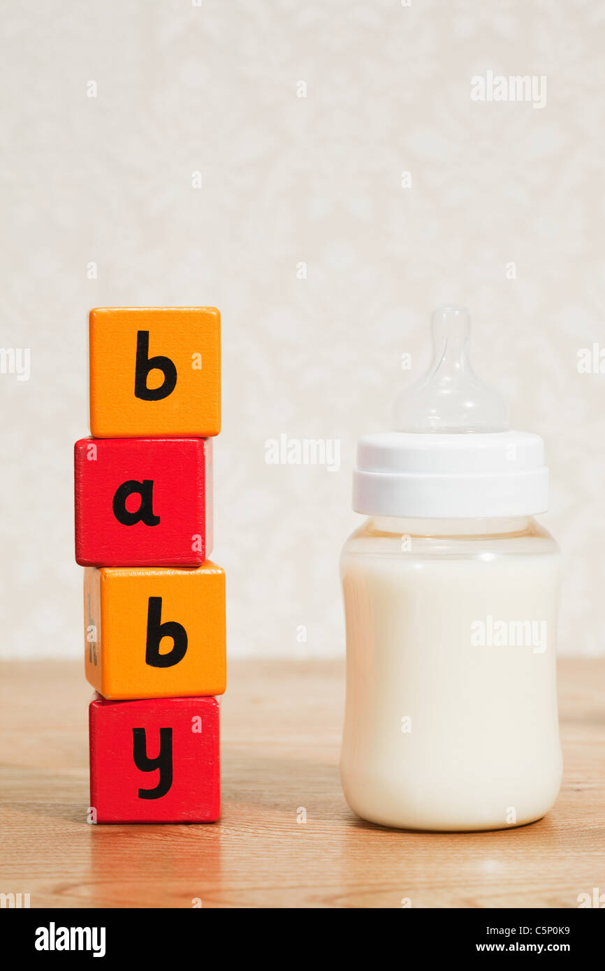 Baby formula and alphabet blocks Stock Photo - Alamy