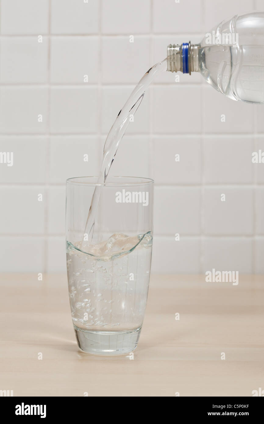 Pouring mineral water into glass Stock Photo - Alamy