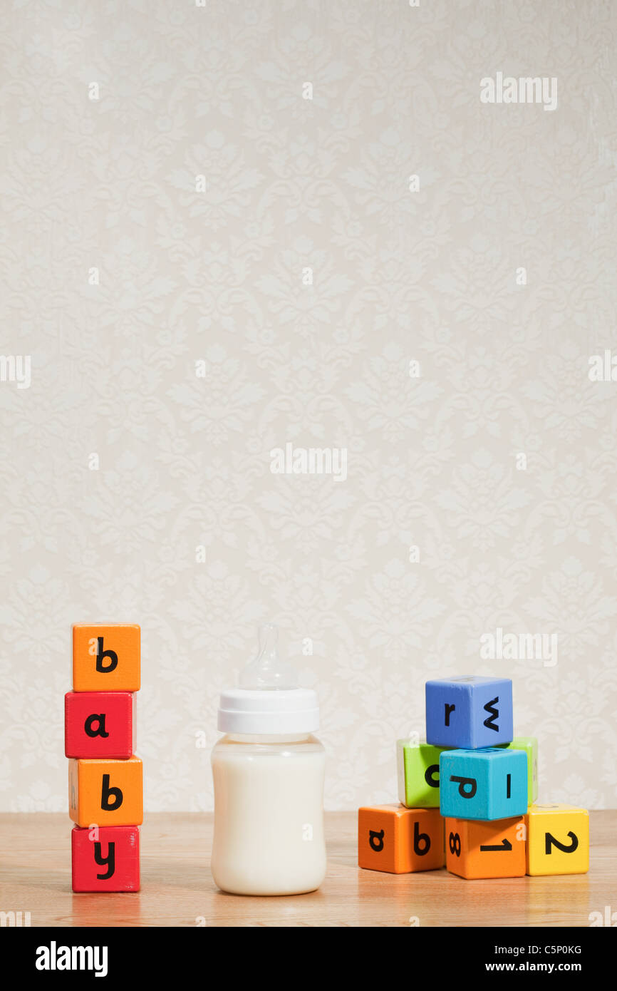 Baby formula and alphabet blocks Stock Photo - Alamy
