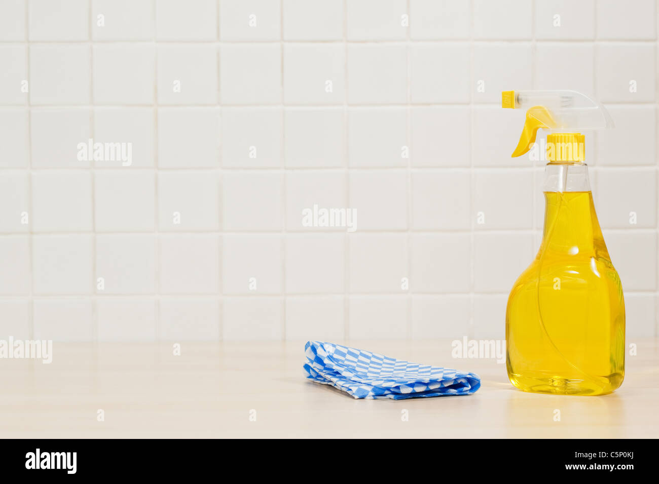 Bottle of yellow cleaning fluid and cleaning cloth Stock Photo - Alamy