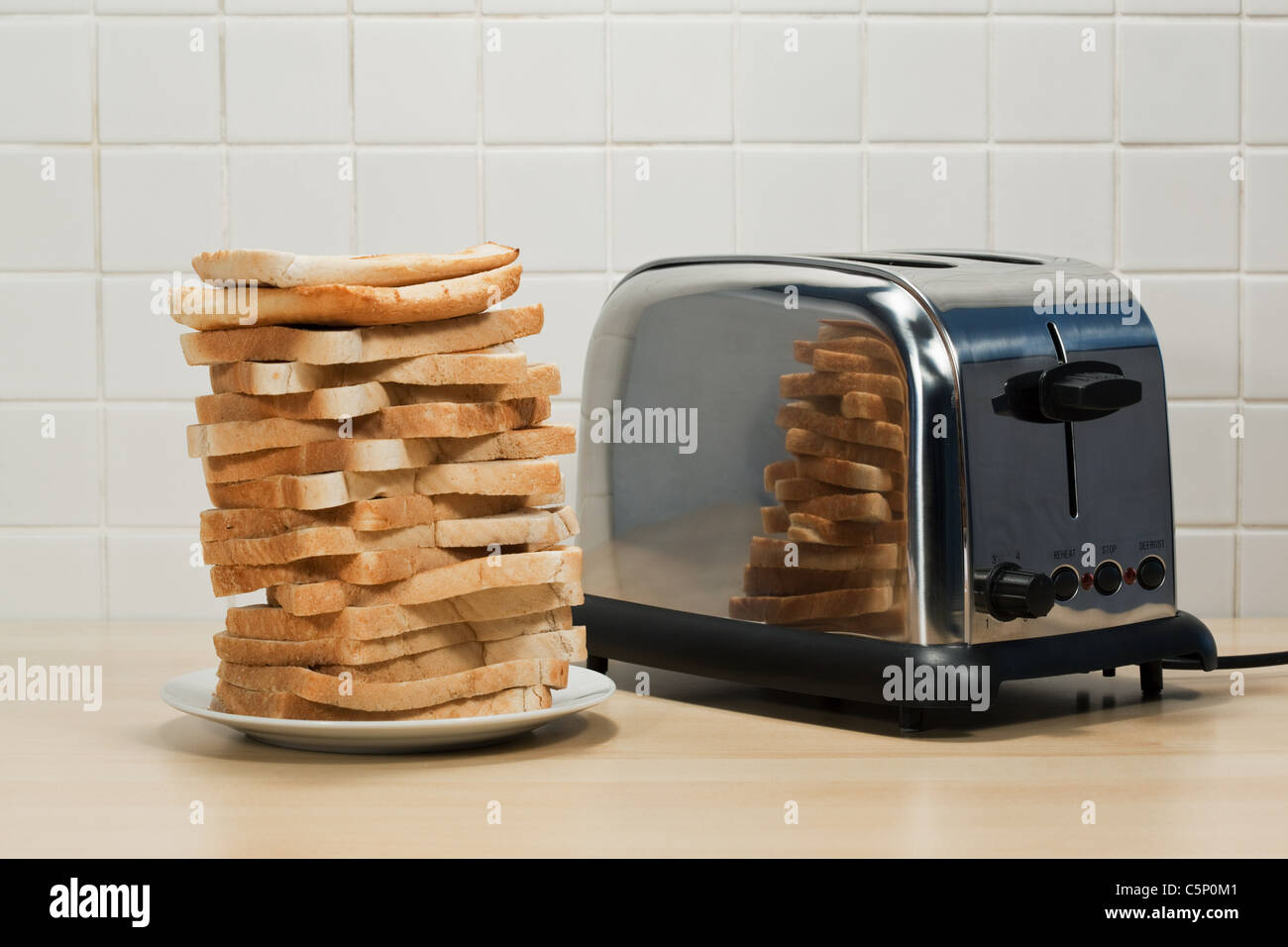 Stack of toast and toaster Stock Photo - Alamy