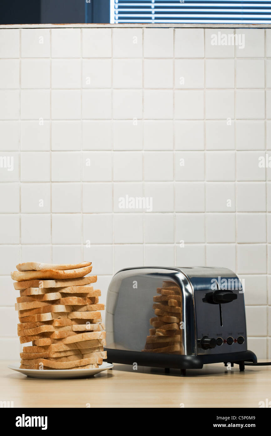 Stack of toast and toaster Stock Photo - Alamy