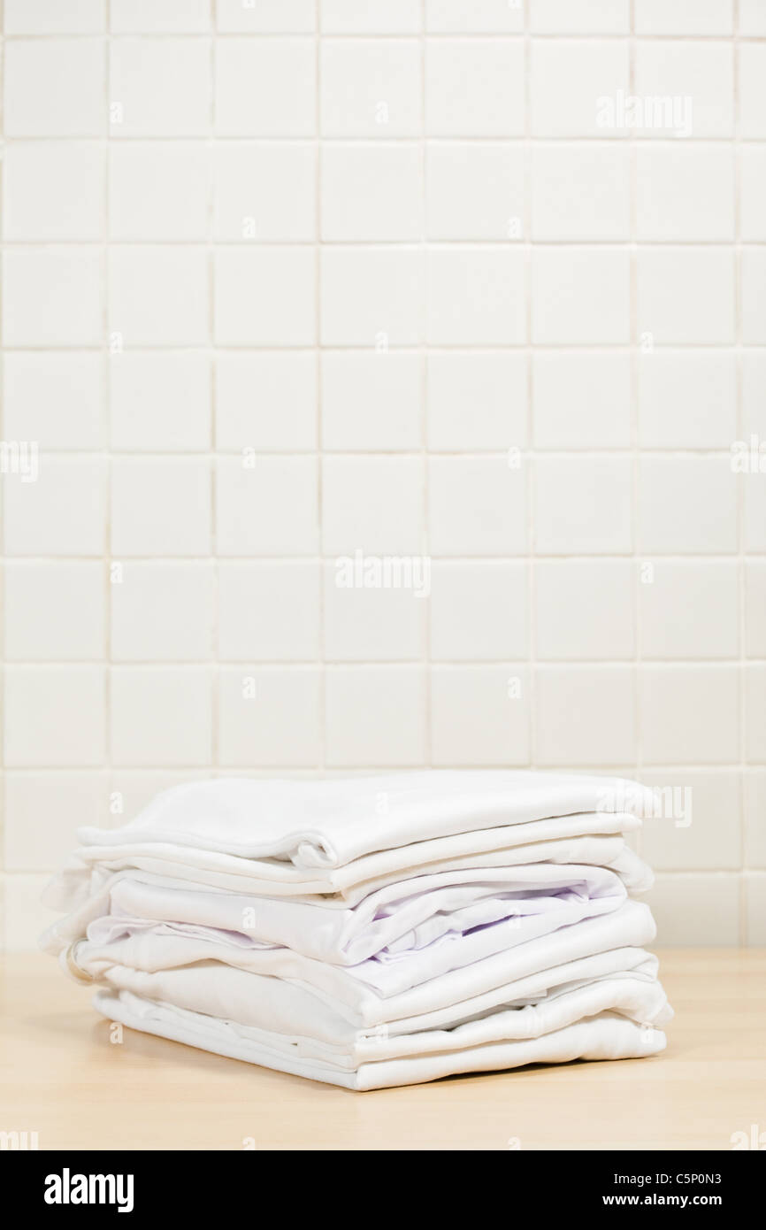 Piles of clean white laundry Stock Photo - Alamy